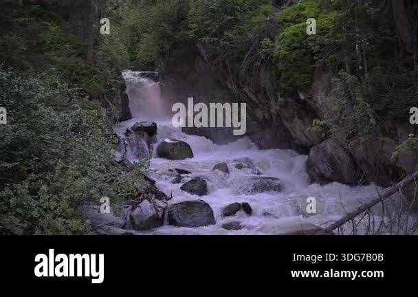 Scenic mountain river rushing through rocky gorge in Austrian Alps with ...
