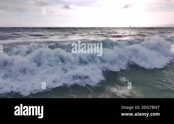 Waves spreading on shoreline. Ocean sea waves in motion. Rolling waves ...