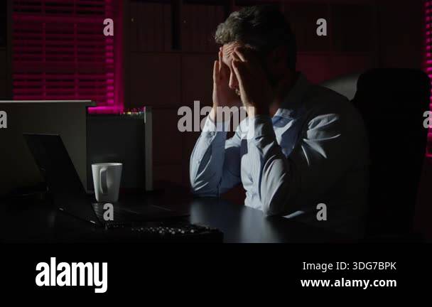 Overworked man tired and stressed indoors. Overworked office worker ...