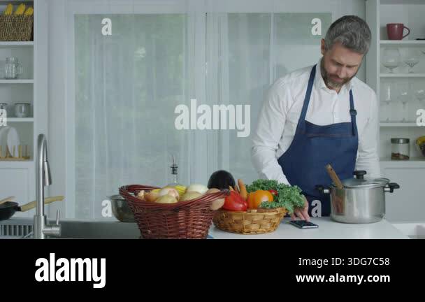 Chef cooking healthy meal at home. Middle aged Man cooking fresh ...