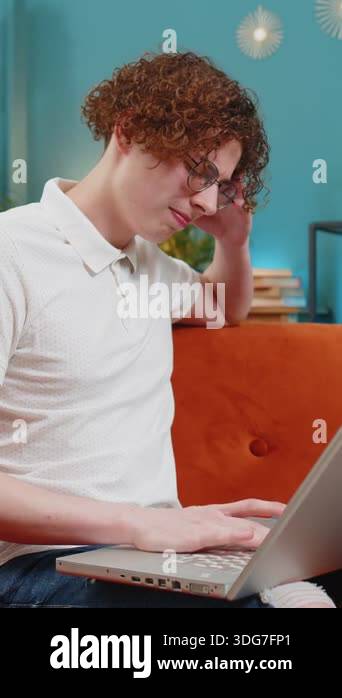 Tired Caucasian man freelancer using laptop, suffering from headache ...