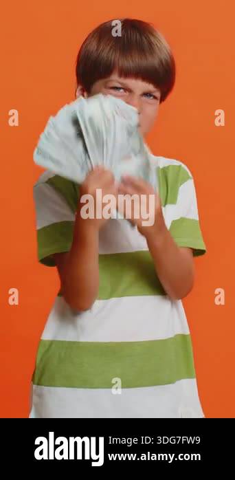 Rich pleased happy young preteen child boy kid waving money dollar cash ...