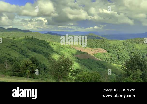 Slow panning shot of mountain landscape during daytime in Asia. Lush ...