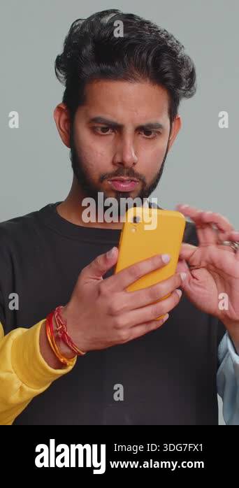 Indian man use mobile cell phone typing browsing, loses becoming ...