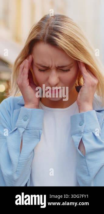 Displeased exhausted Caucasian woman rubbing temples to cure headache ...