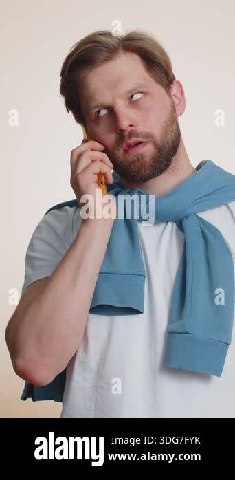 Disinterested young Caucasian man having annoyed boring talk on ...