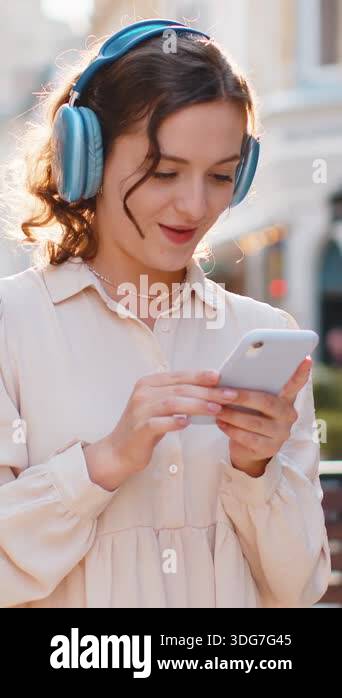 Happy relaxed overjoyed pretty young woman in wireless headphones ...