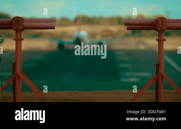 Glide slope masts framing airplane accelerating on runway during ...