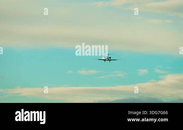 Jet flying in blue sky with layered white clouds. Aircraft moving ...