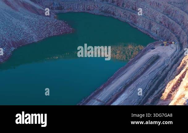 Flooded quarry basin forming deep excavation with turquoise water ...