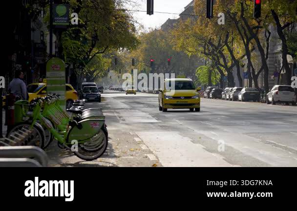 Budapest, Hungary - November 1, 2024: A yellow Tesla and a large tour ...