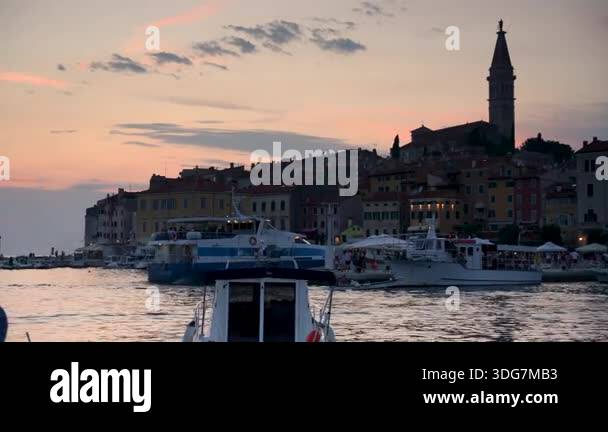 Rovinj, Croatia - August 16, 2025: Sunset light casts a golden glow ...