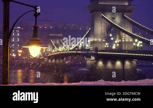 Budapest, Hungary - January 6, 2026: Snowflakes fall past a glowing ...