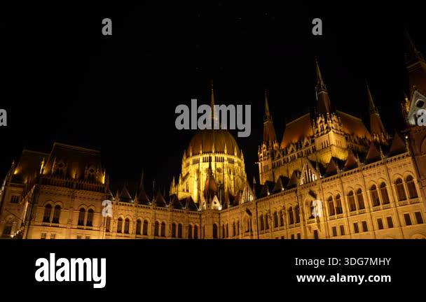 Budapest, Hungary - Parliament building at night. Birds are circling ...