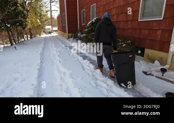 Berkeley Heights, NJ, USA - 01-30-2022: young man bringing the trash ...
