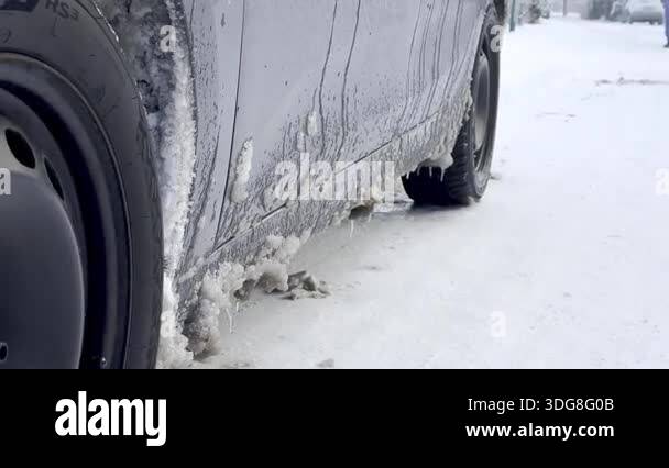 Close u of a car standing on snow covered road , winter season and ...