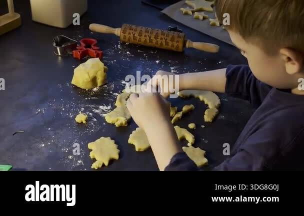 Close up of a boy making cookies from shortcrust pastry, Christmas ...