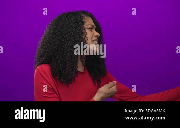 African american woman pushes imaginary object with outstretched arm ...