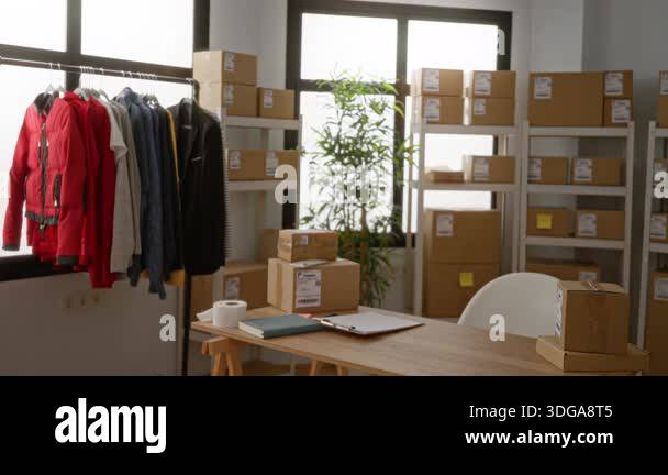 Ecommerce packing room with stacked cardboard boxes, clothing rack ...