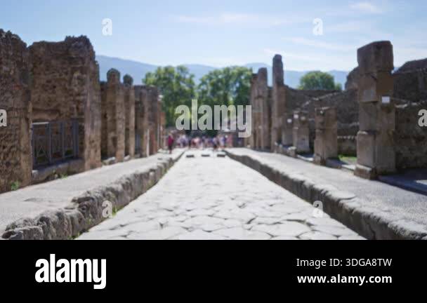 Pompeii ruins street with shallow blurred bokeh focus and ancient stone ...