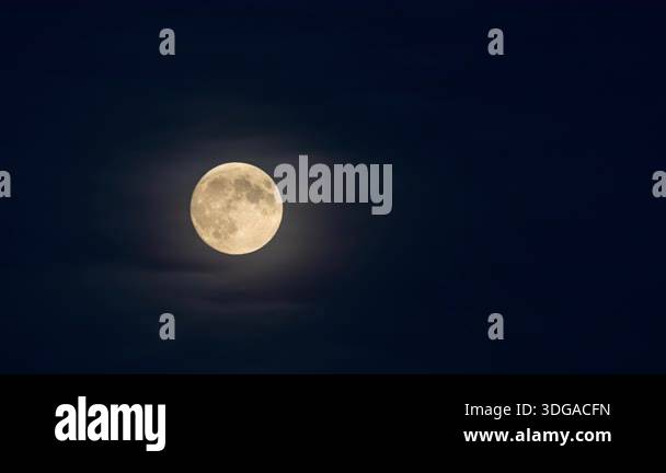 Full moon time lapse video. The moon is moving on the dark night sky ...