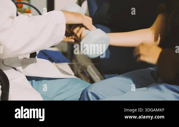 Physical therapist doctor teach senior man patient using dumbbell ...