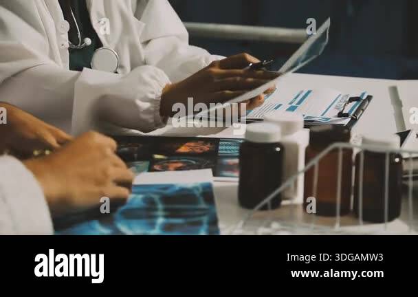 Medical team meeting analyzing blood test results in hospital ...