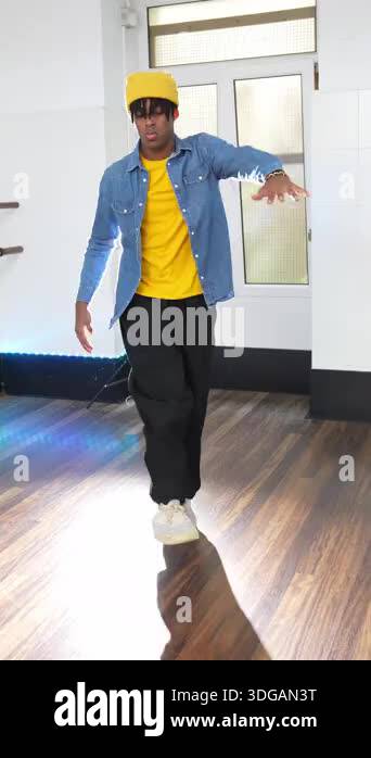 Young male dancer performing dynamic afro hip hop choreography ...