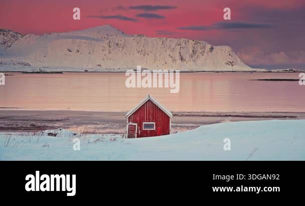 Lofoten island winter landscape with lonely red cabin on the nordic sea ...