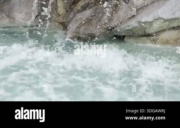 Sea waves gently rolling onto a rocky shore with small stones. Tranquil ...