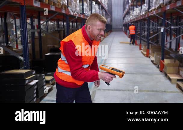 Logistics professional dancing cheerfully while scanning packages in ...