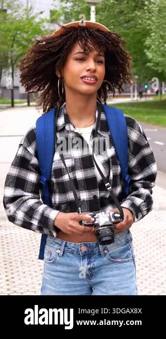 Young female student wandering college campus, capturing moments with ...