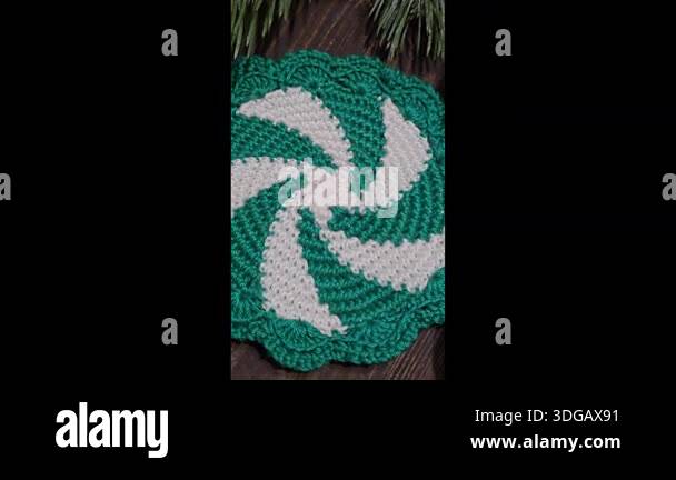 Handcrafted colorful candy-shaped potholders on a wooden background ...