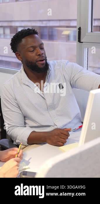 Young african american manager explaining project details to coworker ...