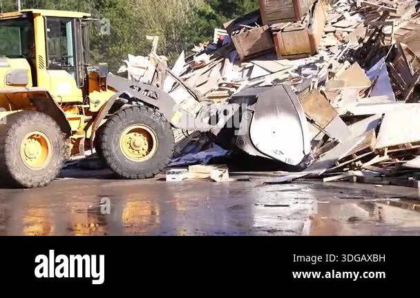Wheel loader efficiently managing wood waste at a recycling facility ...