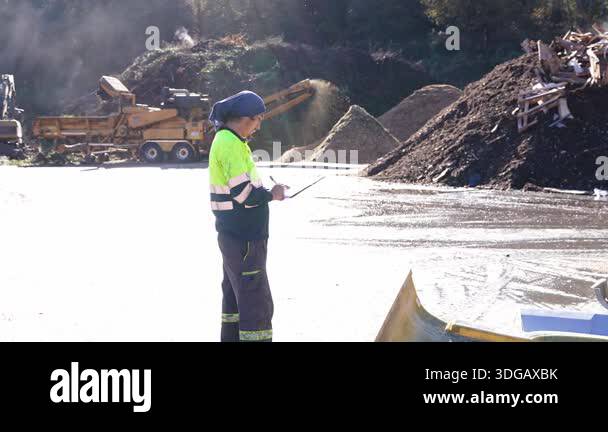 Waste management worker monitors ensuring efficient processing and ...
