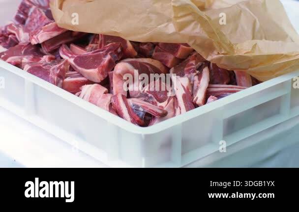 Beef steaks in a plastic box of a restaurant. Raw meat pile for a ...