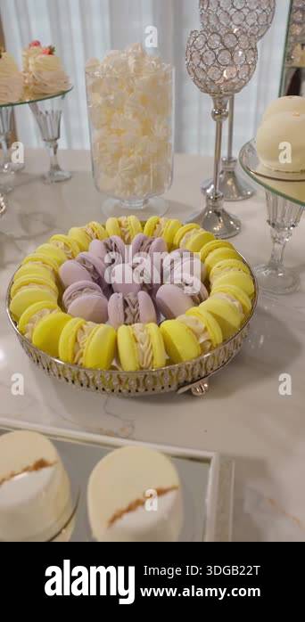 Colorful macarons arranged on elegant serving tray with glass decor ...