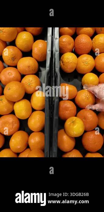 Hand wearing plastic glove picking an orange in supermarket Stock Video ...