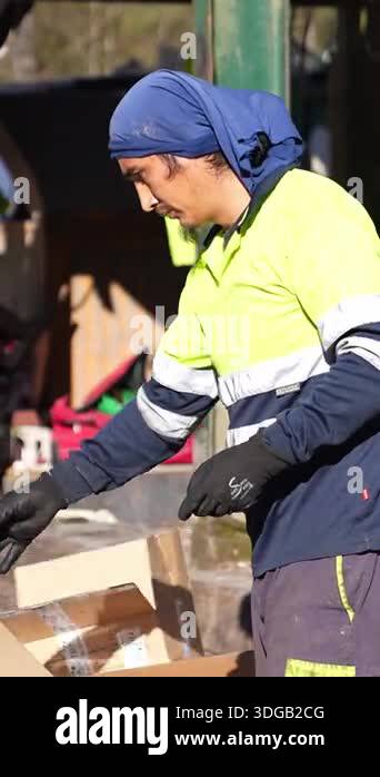 Waste management worker managing various recyclable materials like ...