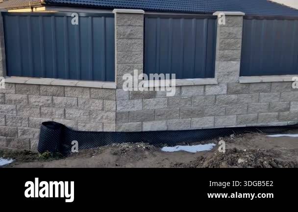 retaining wall concrete blocks that imitate natural stone. fence dark ...