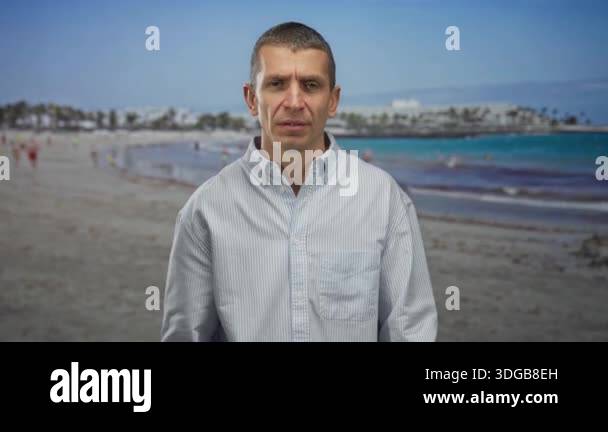 Man contemplating at a sunny beach with calm sea in the background and ...