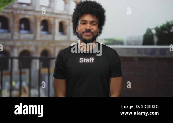 Smiling man in staff uniform makes victory sign at rome's iconic ...