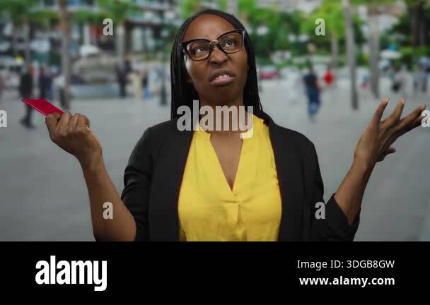 Woman holding austrian passport outdoors with city background ...
