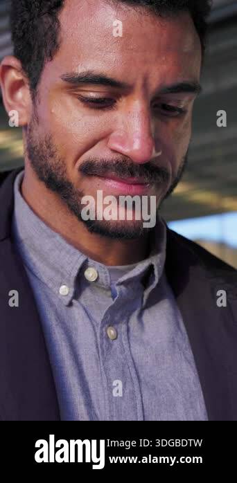 Vertical HD video. Portrait of young handsome businessman with a beard ...