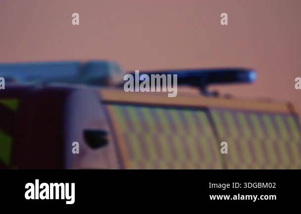 Side view of a red ambulance moving through Antibes during dusk Stock ...
