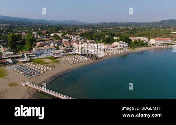 Top down aerial view of turquoise waves crashing on sandy Roda Beach in ...