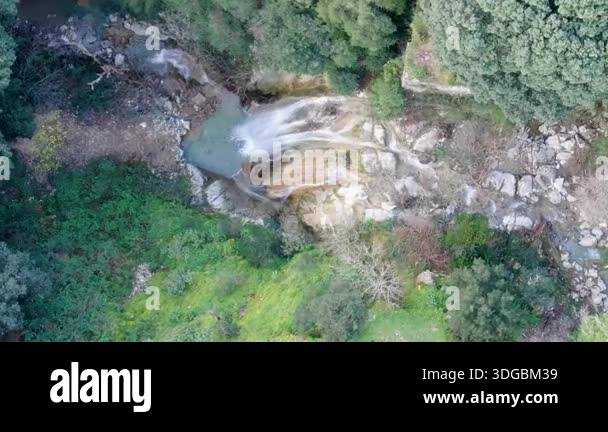 Top Down Aerial Drone View of Waterfall Cascading into Turquoise Pool ...