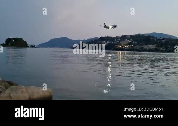 Passenger Airplane Approaching and Landing at Corfu Airport over Water ...
