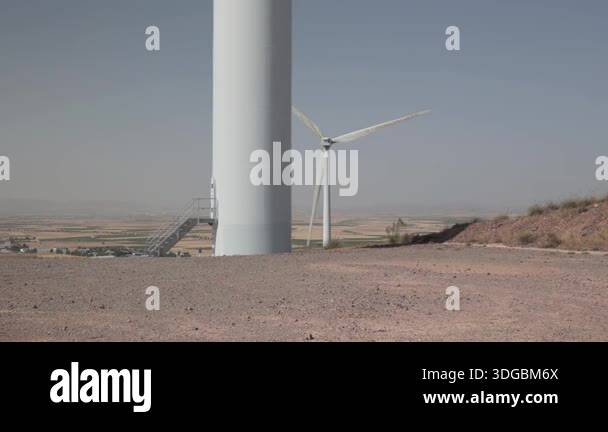 Wind turbines stand tall in an expansive landscape, capturing energy ...